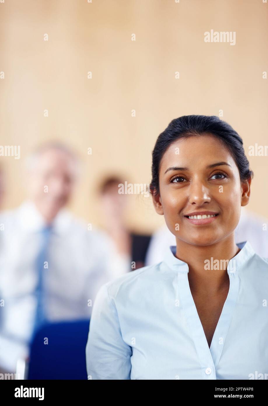 Happy female executive. Focus on female business woman with group of ...