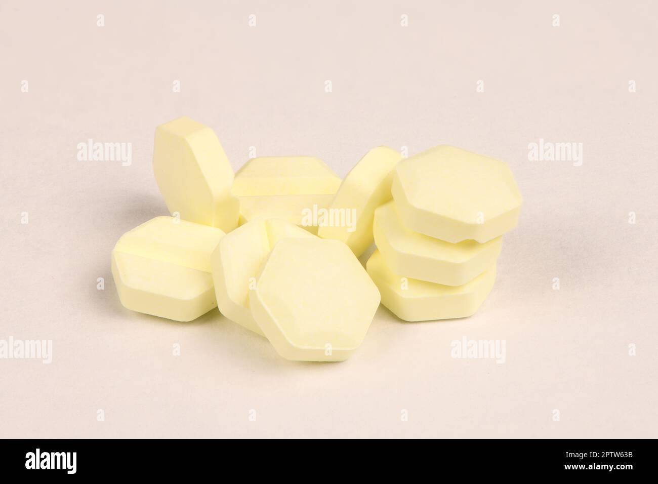 Hexagonal pills on light pink background. Extreme closeup. High ...