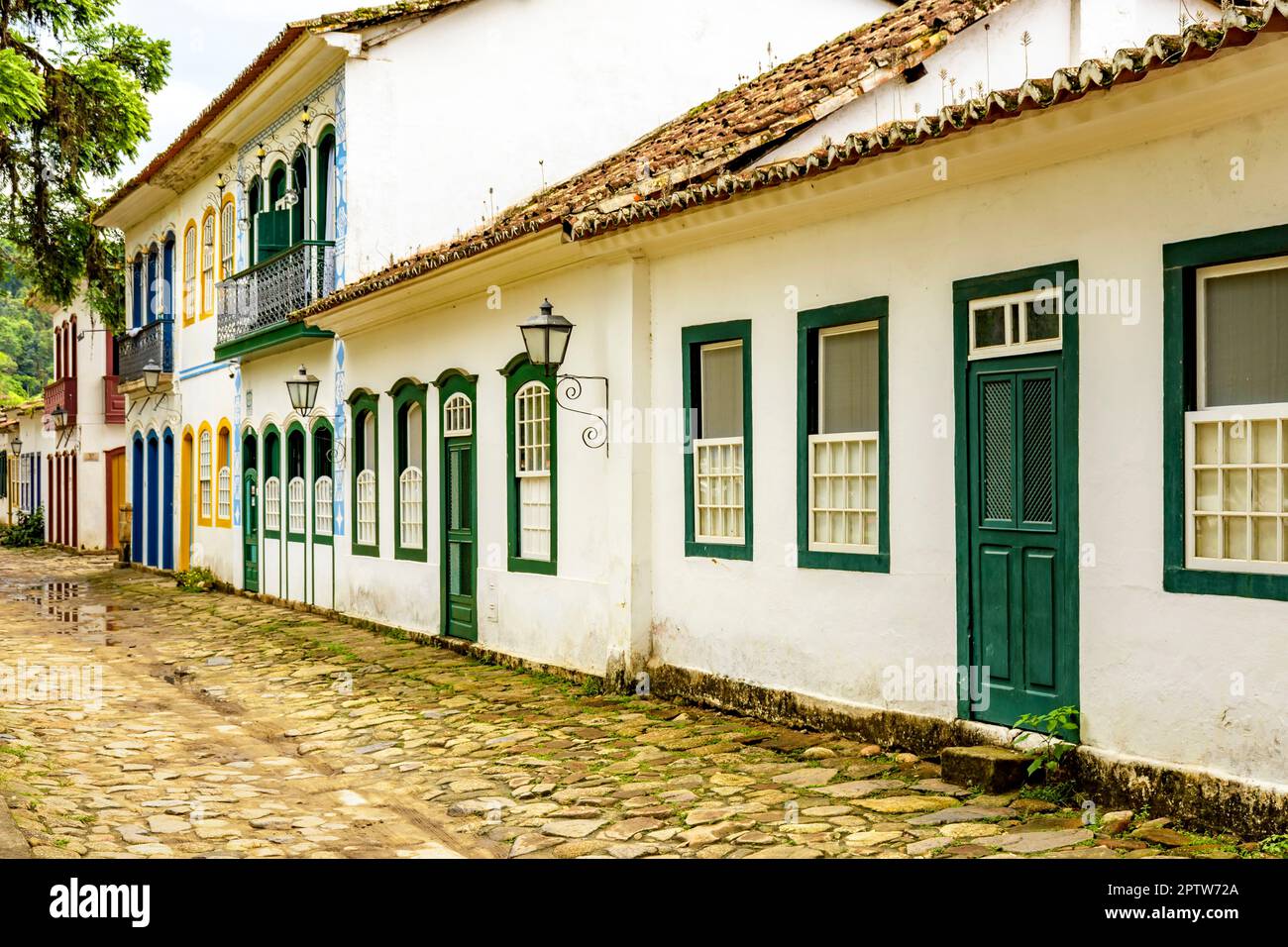 Bucolic street with cobblestone pavement and historic colonial-style ...