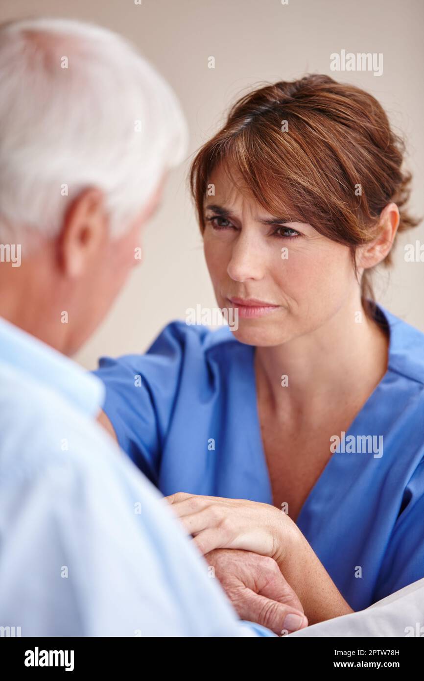 She really cares about her patients. a female nurse checking on her ...
