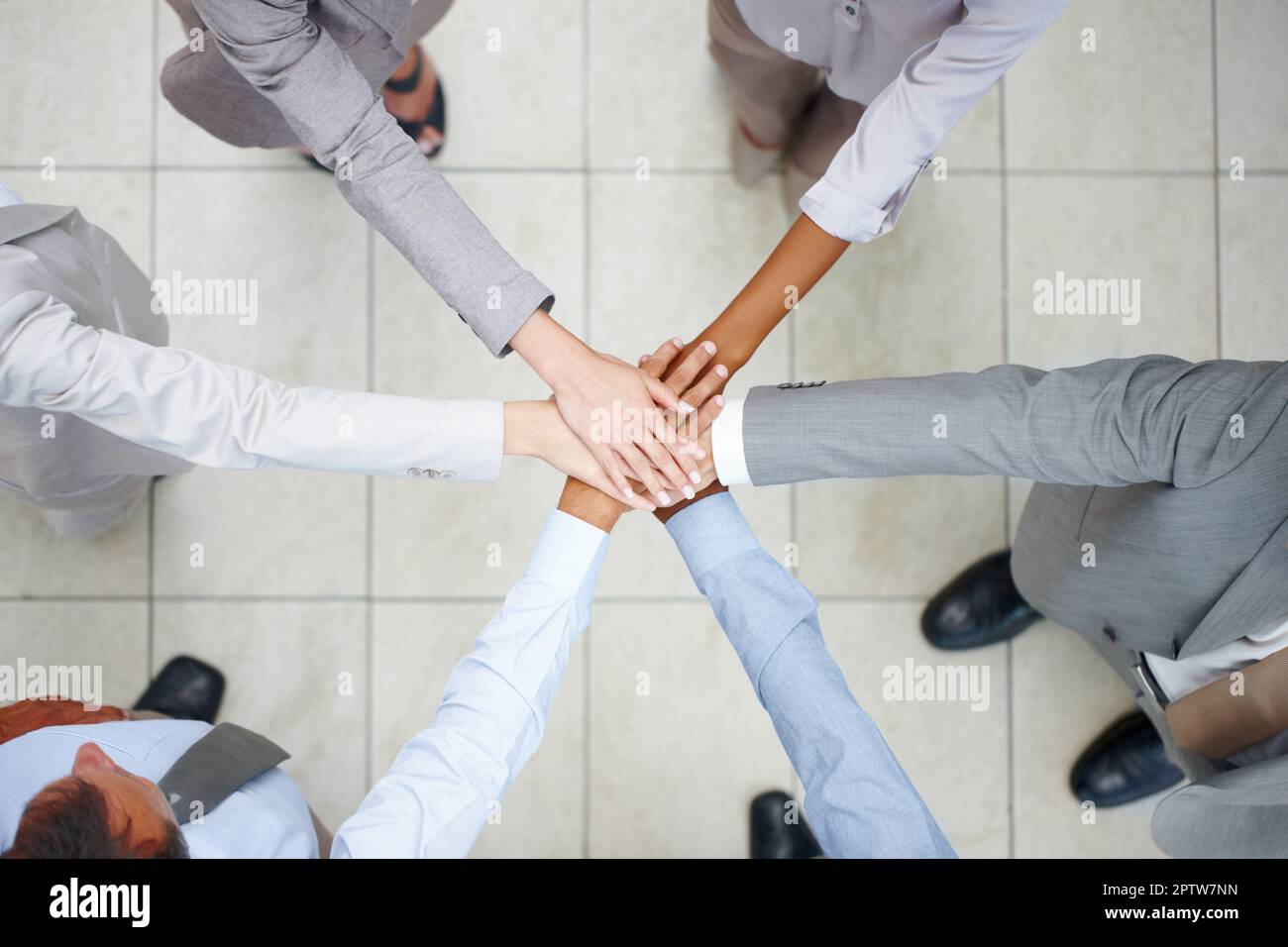 Making deals as a unit - Business teams. Top view of six diverse ...
