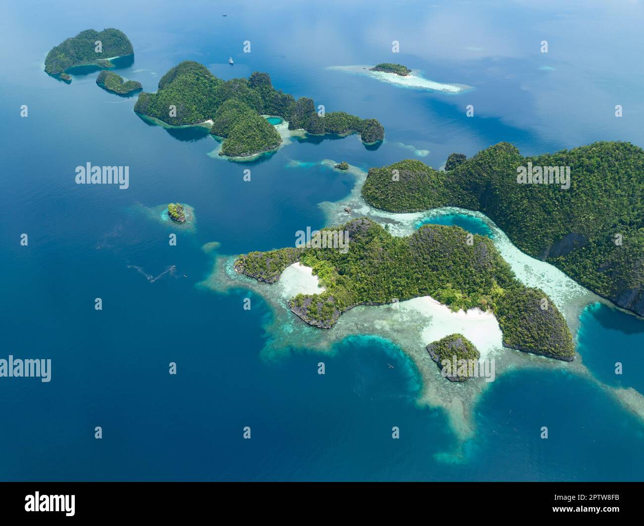 Beautiful coral reefs surround the dramatic limestone islands that rise ...