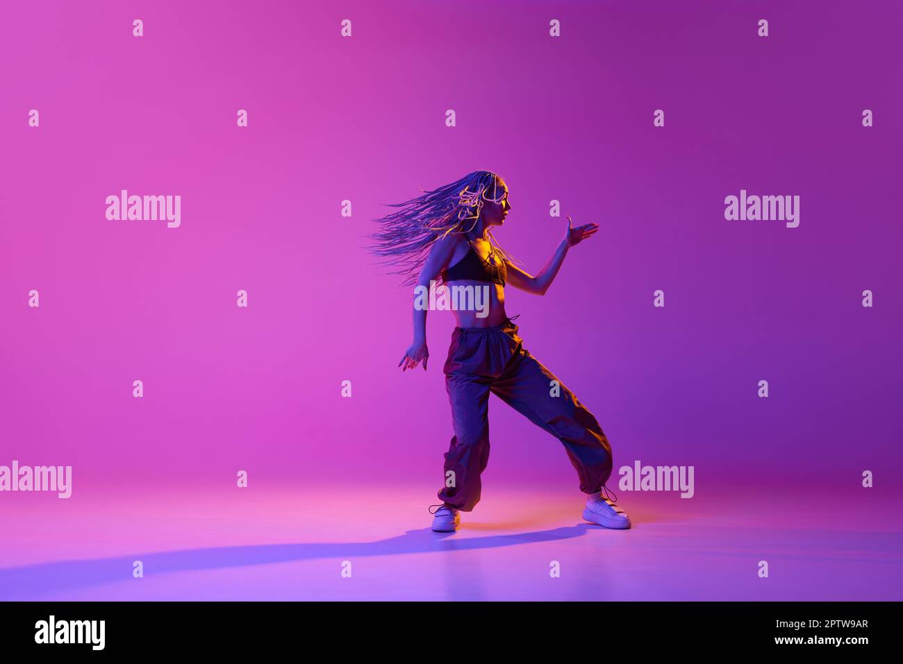 Portrait with young adorable girl with flying hair dancing over ...