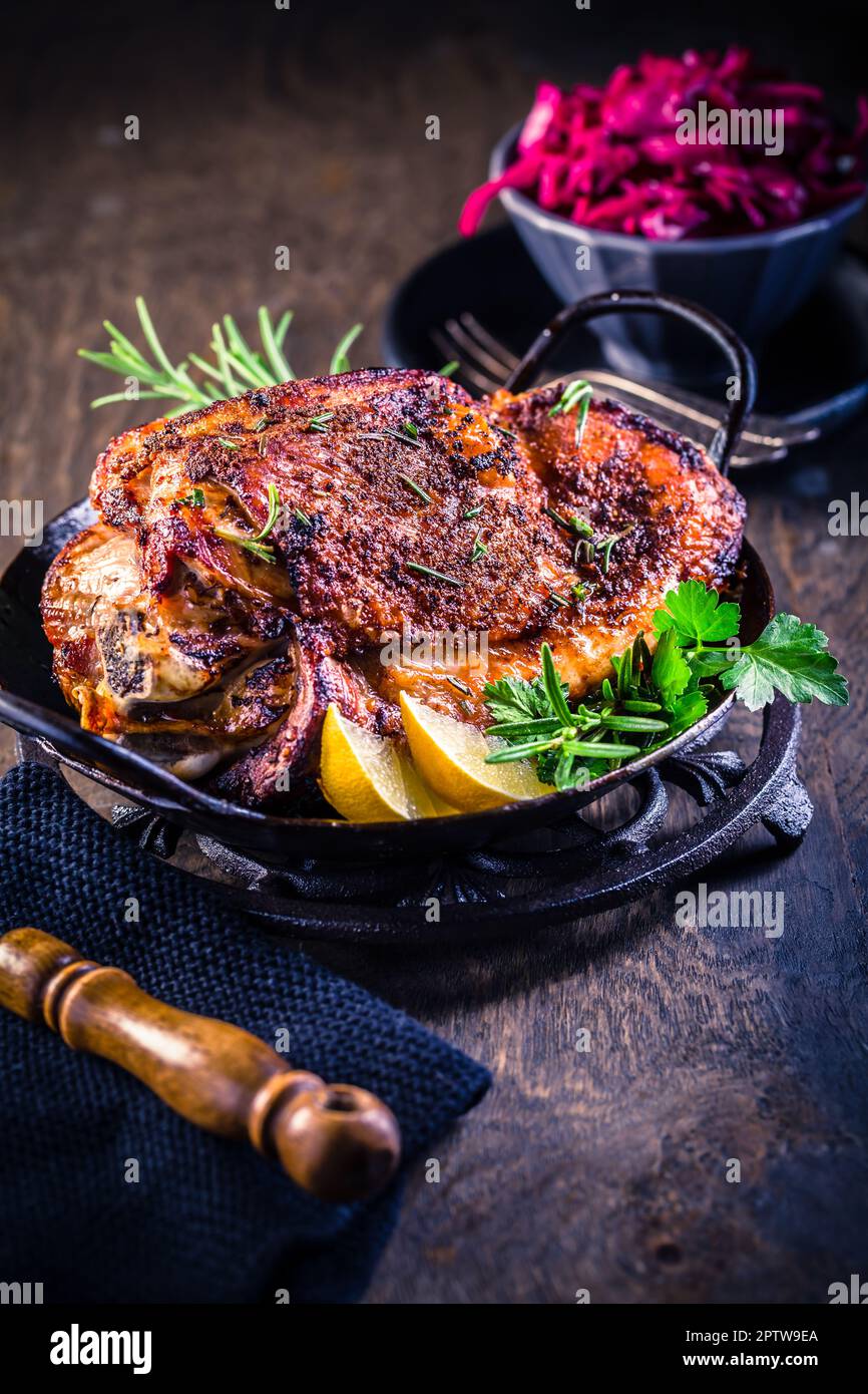 Roasted turkey knuckle with pickled red cabbage salad on wooden ...