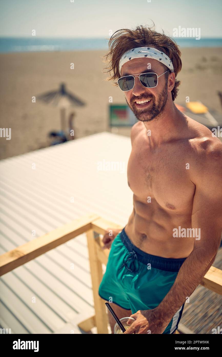 Attractive young man on the beach enjoying at summer vacation Stock ...