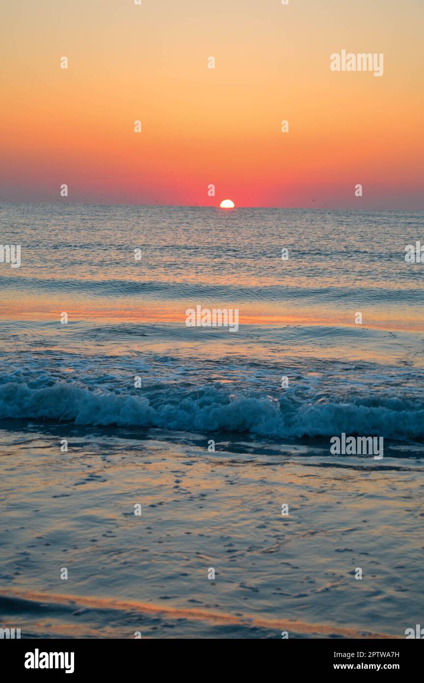 Beautiful summer landscape, sunset at the beach, sparkly sand and waves ...