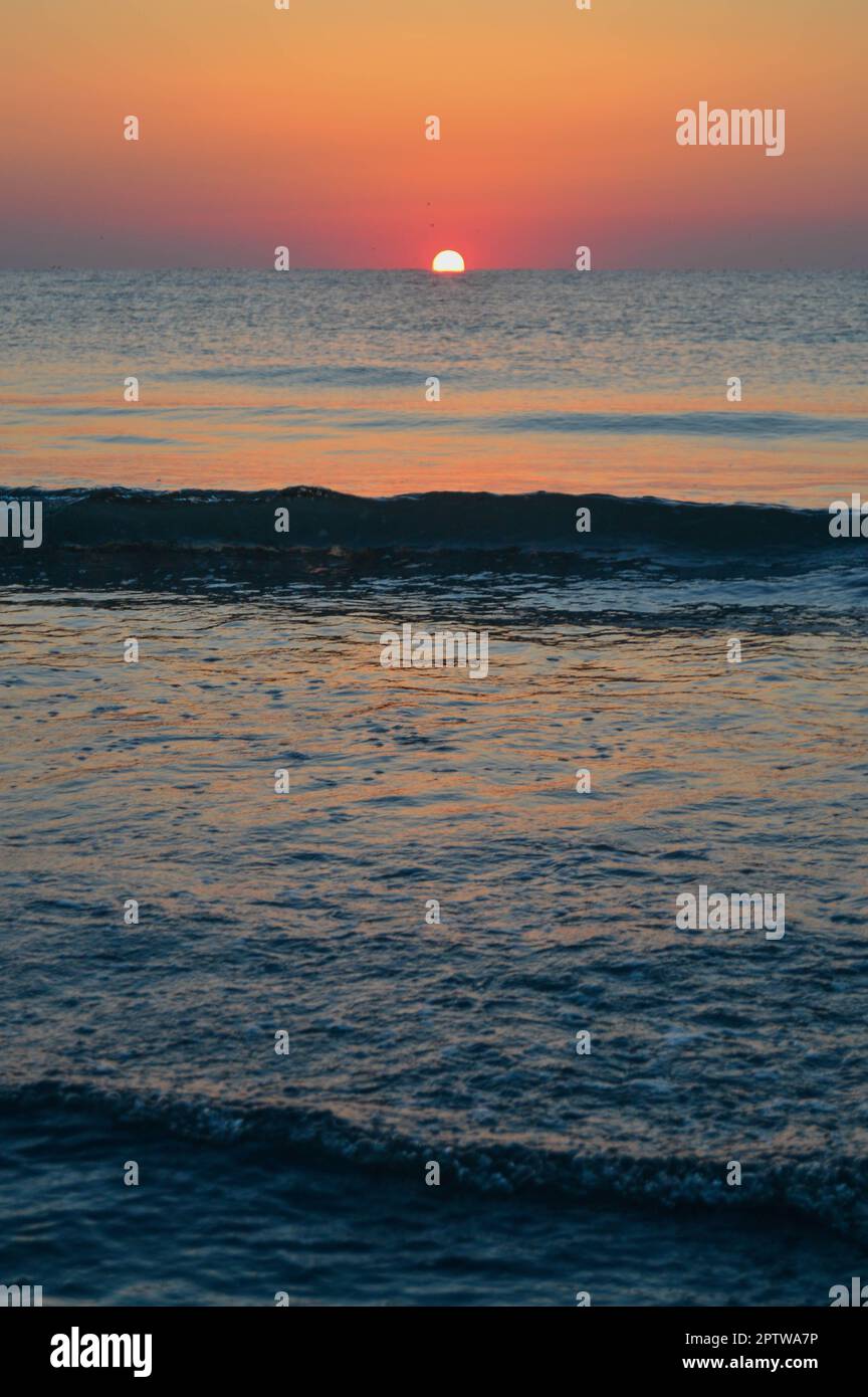 Beautiful summer landscape, sunset at the beach, sparkly sand and waves ...