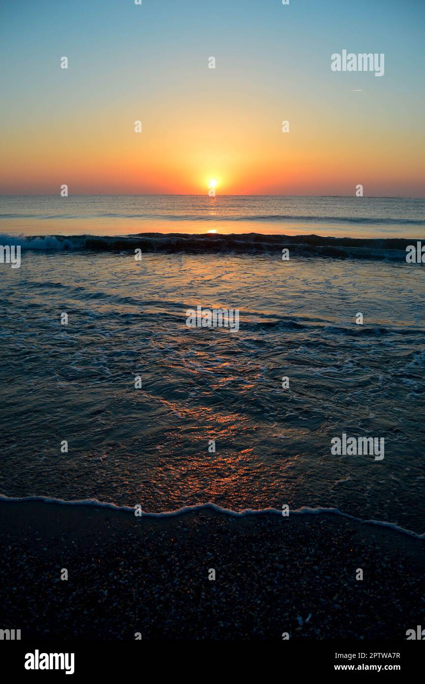 Beautiful summer landscape, sunset at the beach, sparkly sand and waves ...