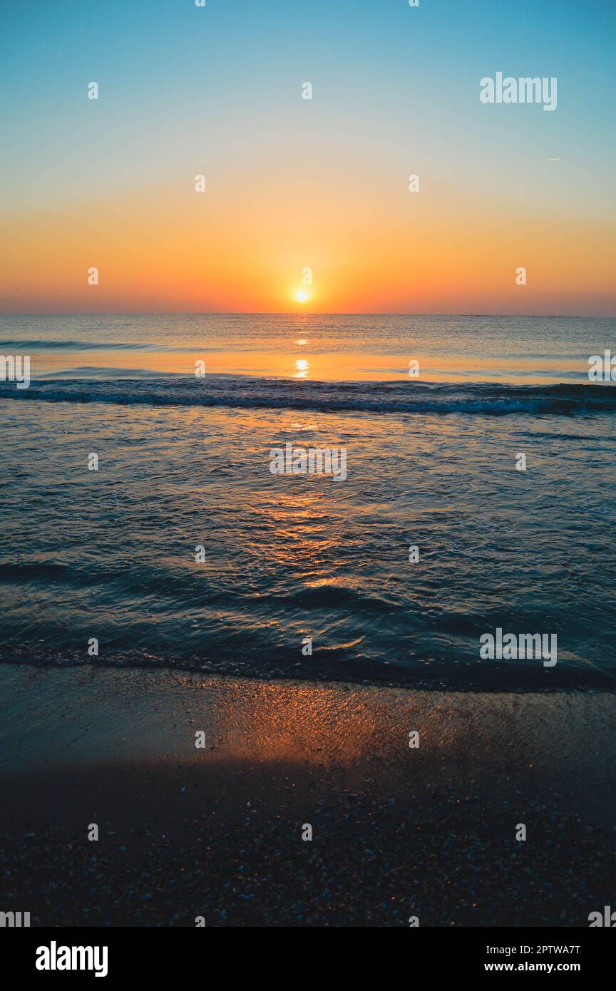 Beautiful summer landscape, sunset at the beach, sparkly sand and waves ...