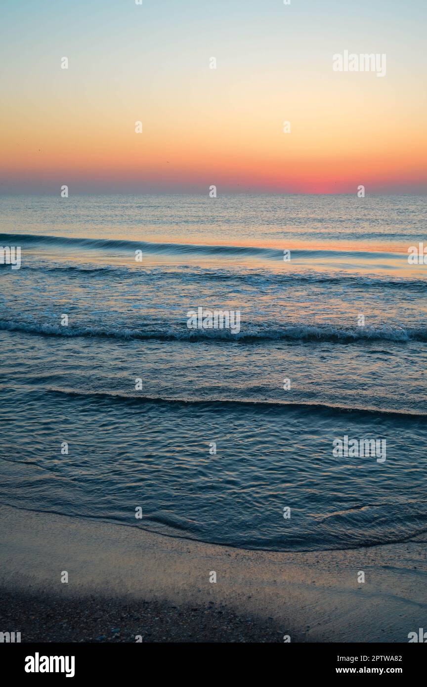 Beautiful summer landscape, sunset at the beach, sparkly sand and waves ...