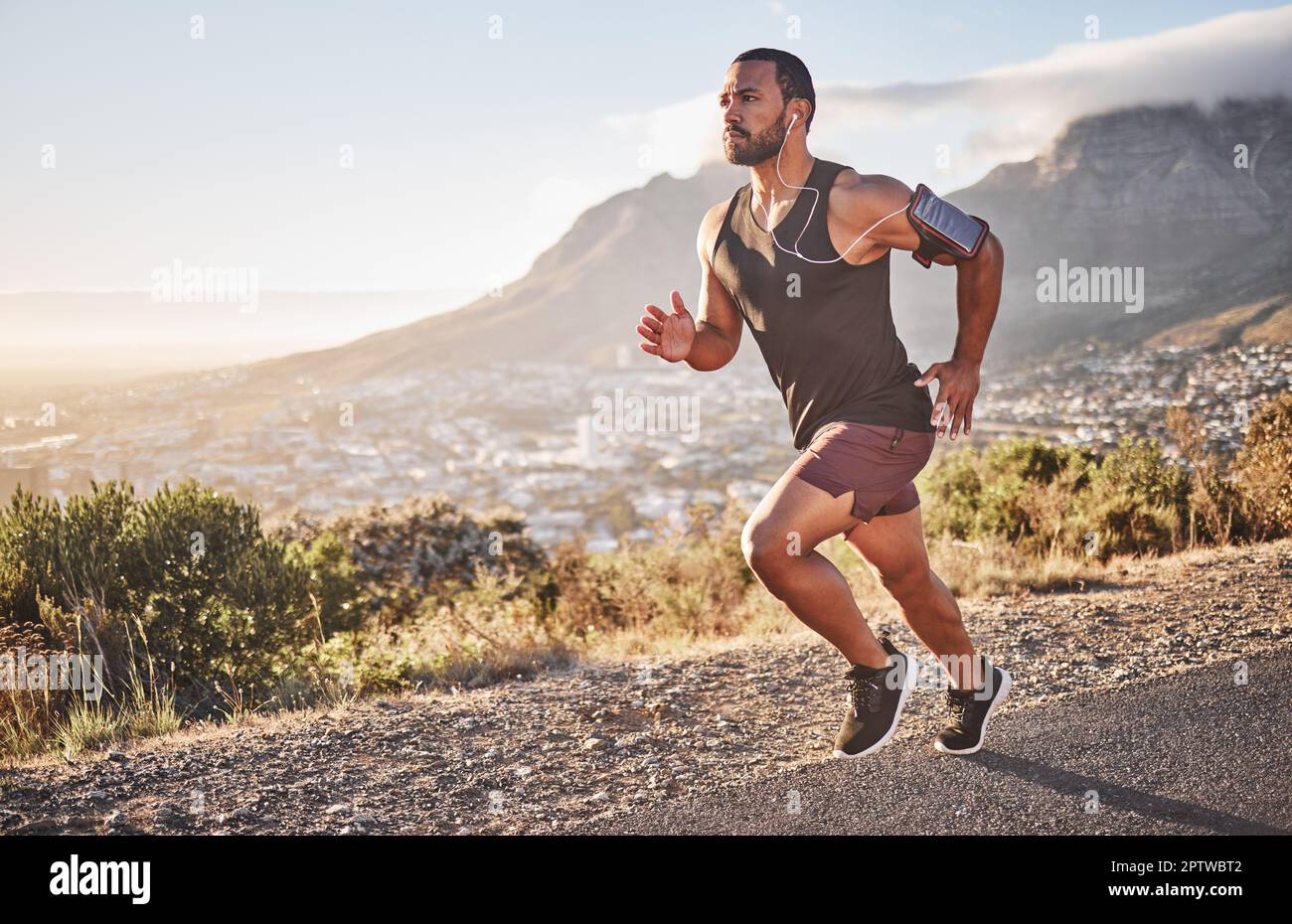 Fitness, sports and man running on mountain with city background doing ...