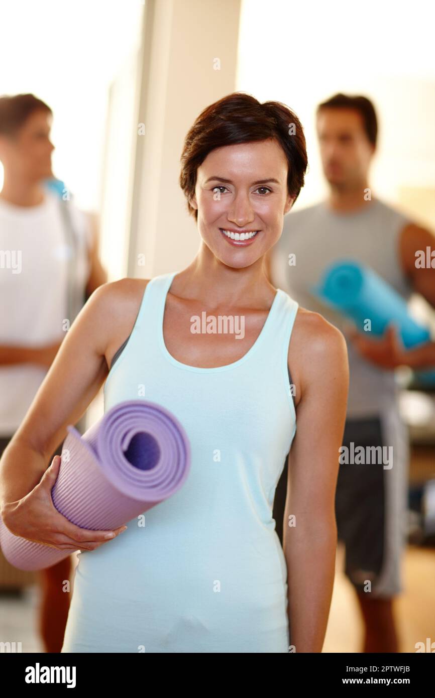 Working towards a lean and flexible body. a beatuiful woman holding her ...