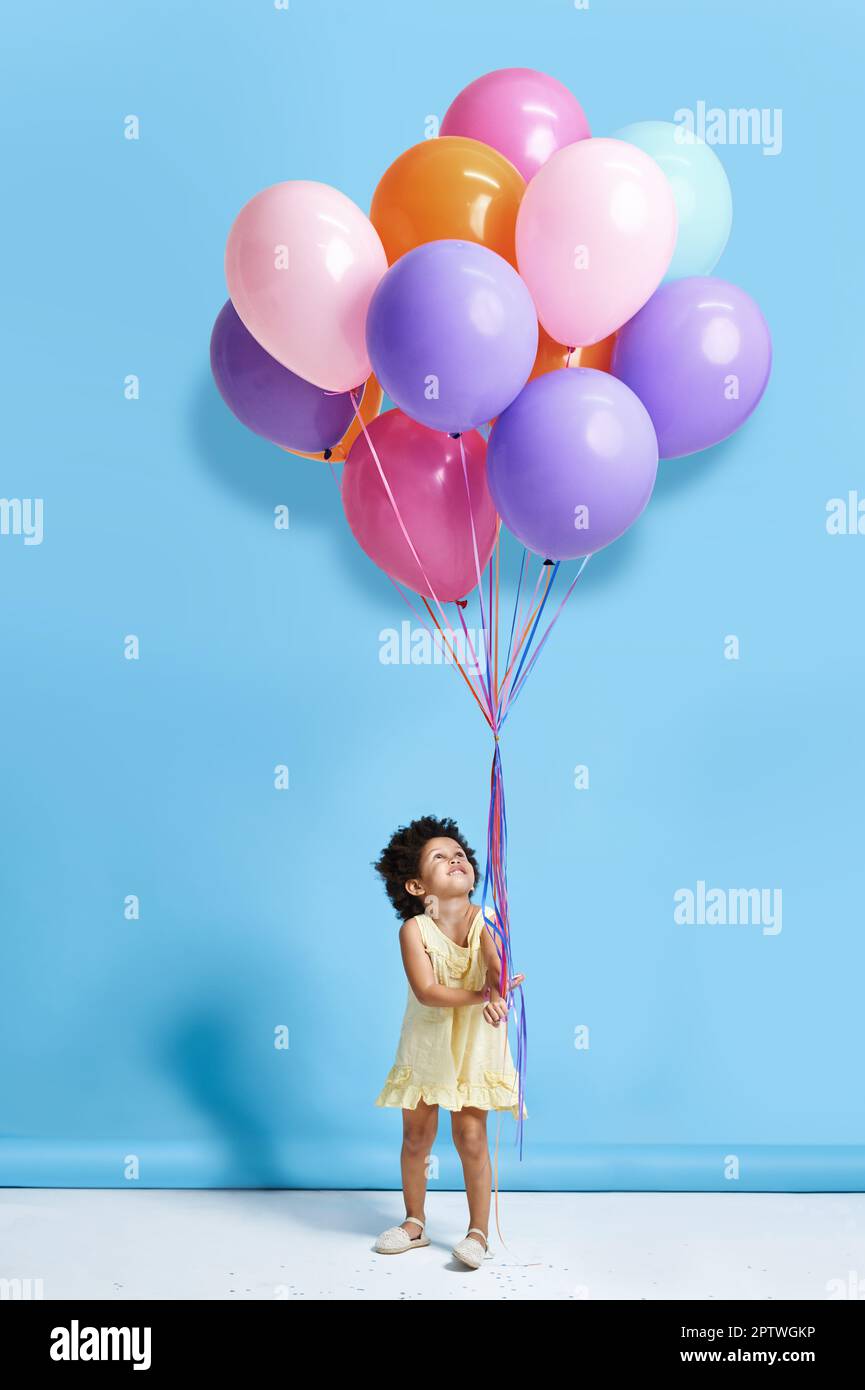 Shall we dance Mr. Balloon. a cute little girl holding a bunch of ...
