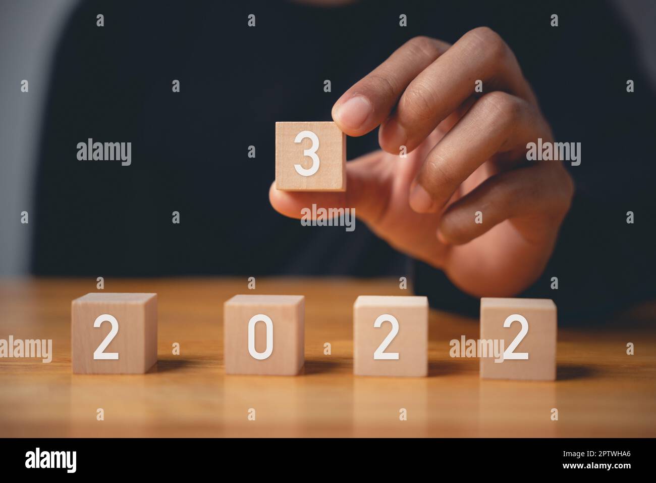 Happy New Year 2023. Happy businessman hand holding number 3 on wooden ...