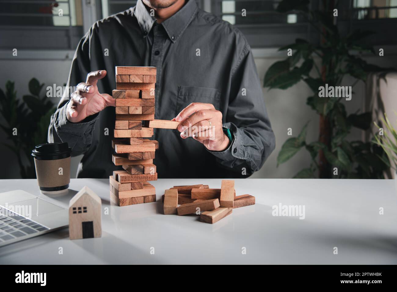Alternative risk plan. Business hand playing tower wooden blocks game ...