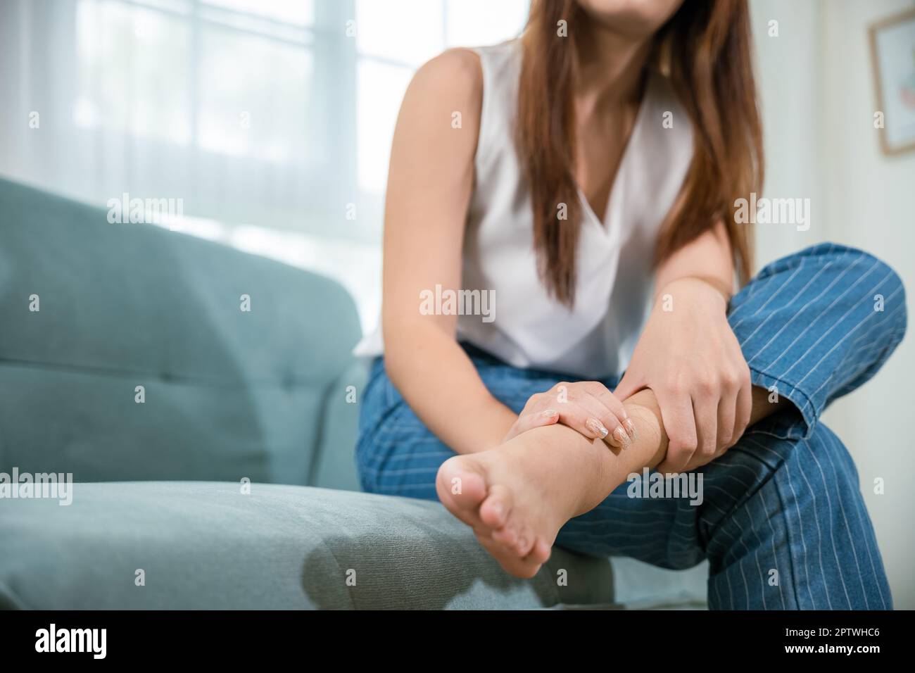 Asian beautiful female problems with foot at home, painful ankle injury ...