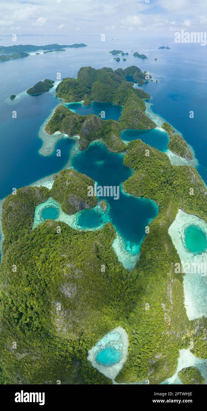 Beautiful coral reefs surround the dramatic limestone islands that rise ...