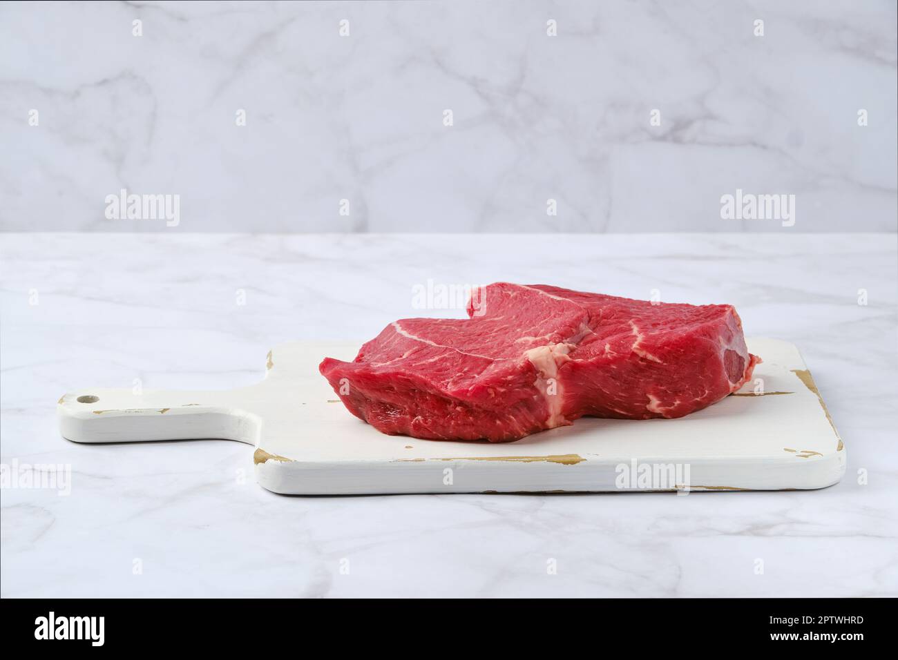 Slice of raw top side beef steak Stock Photo - Alamy