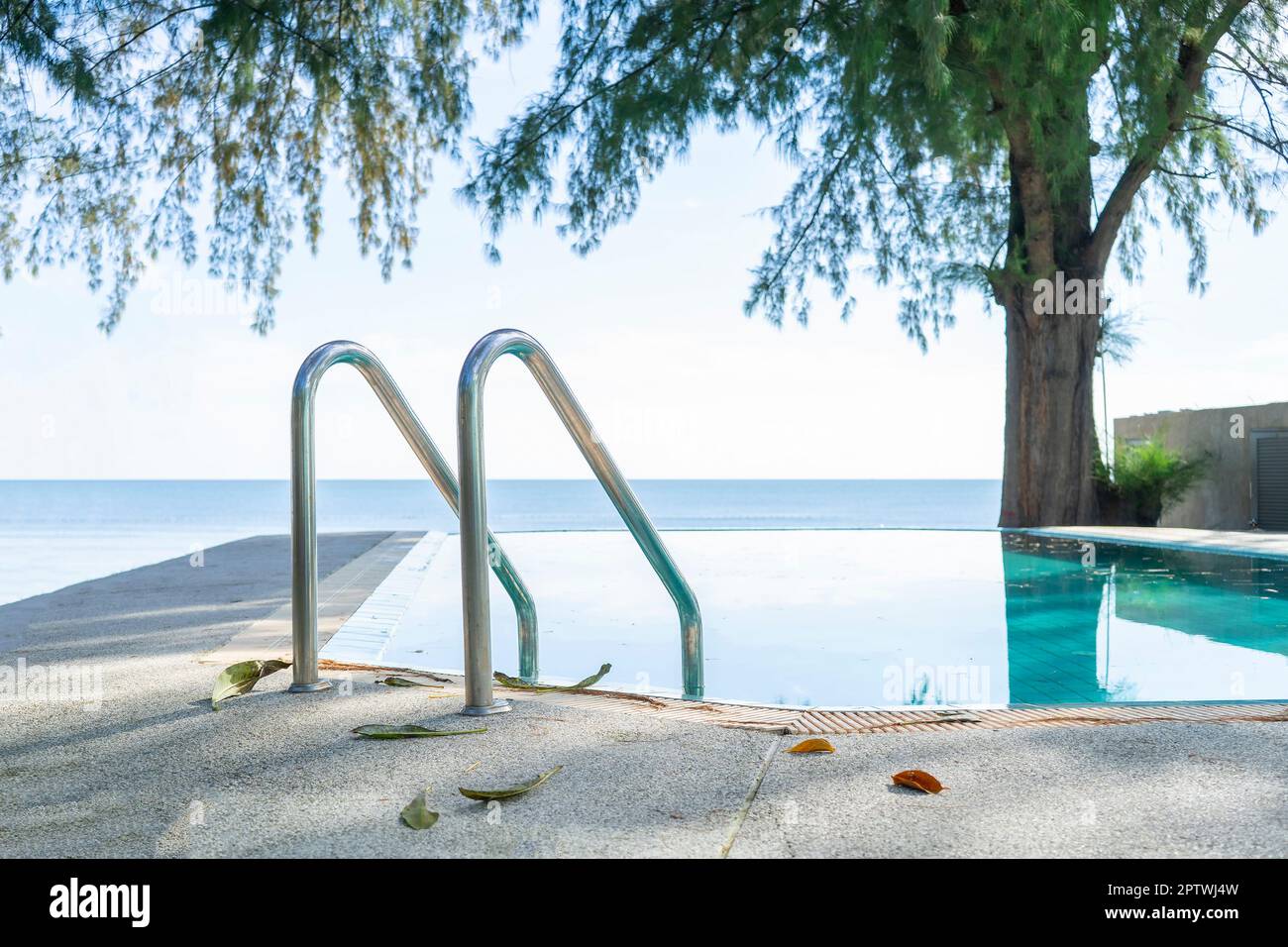 Pool with sea under the trees relax Stock Photo - Alamy