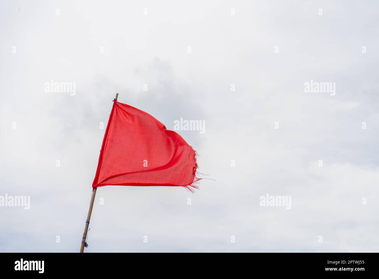 Red flag warning flags wind blue sky Stock Photo - Alamy