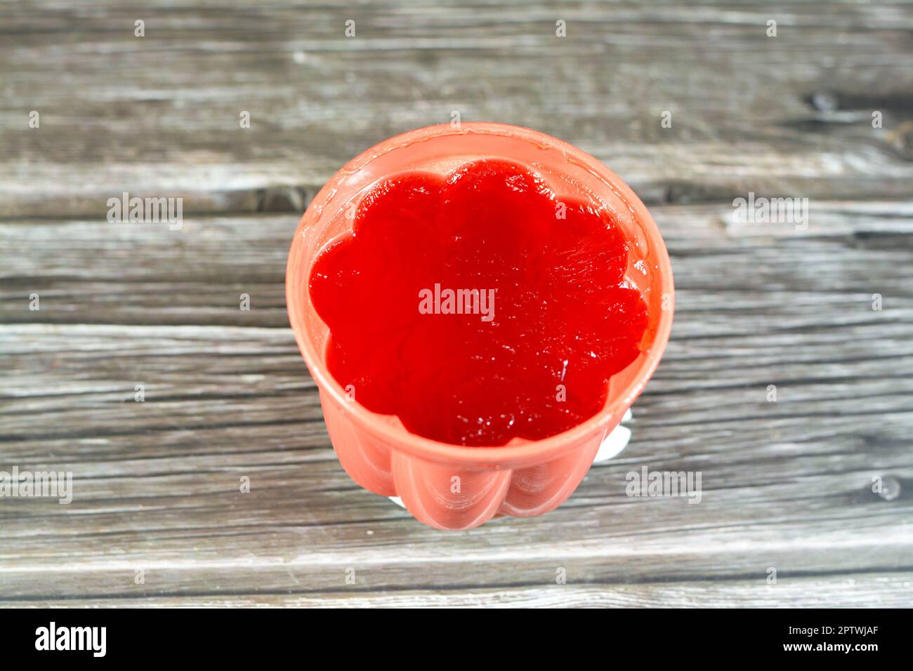 A close up of a delicious sweet red jelly pudding strawberry flavored ...