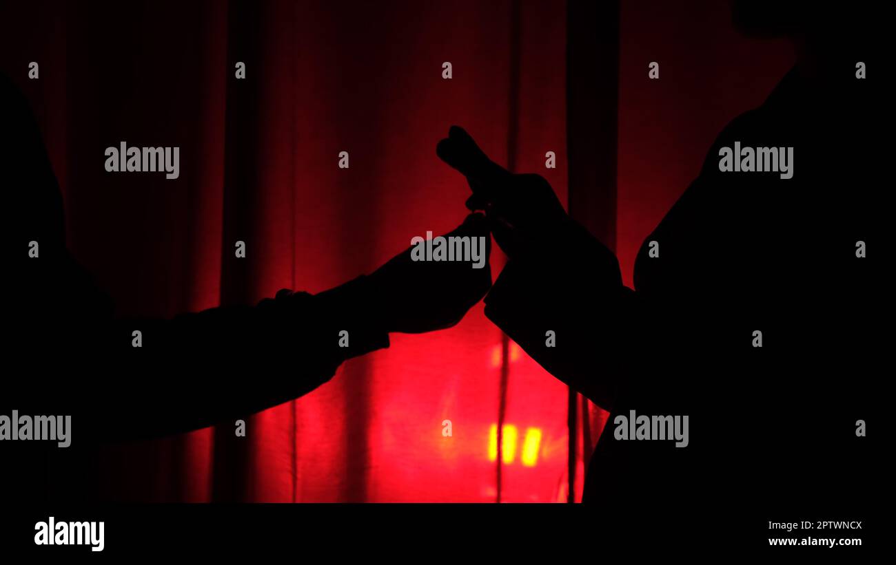 silhouette of Young woman rejecting marriage proposal on dark red ...