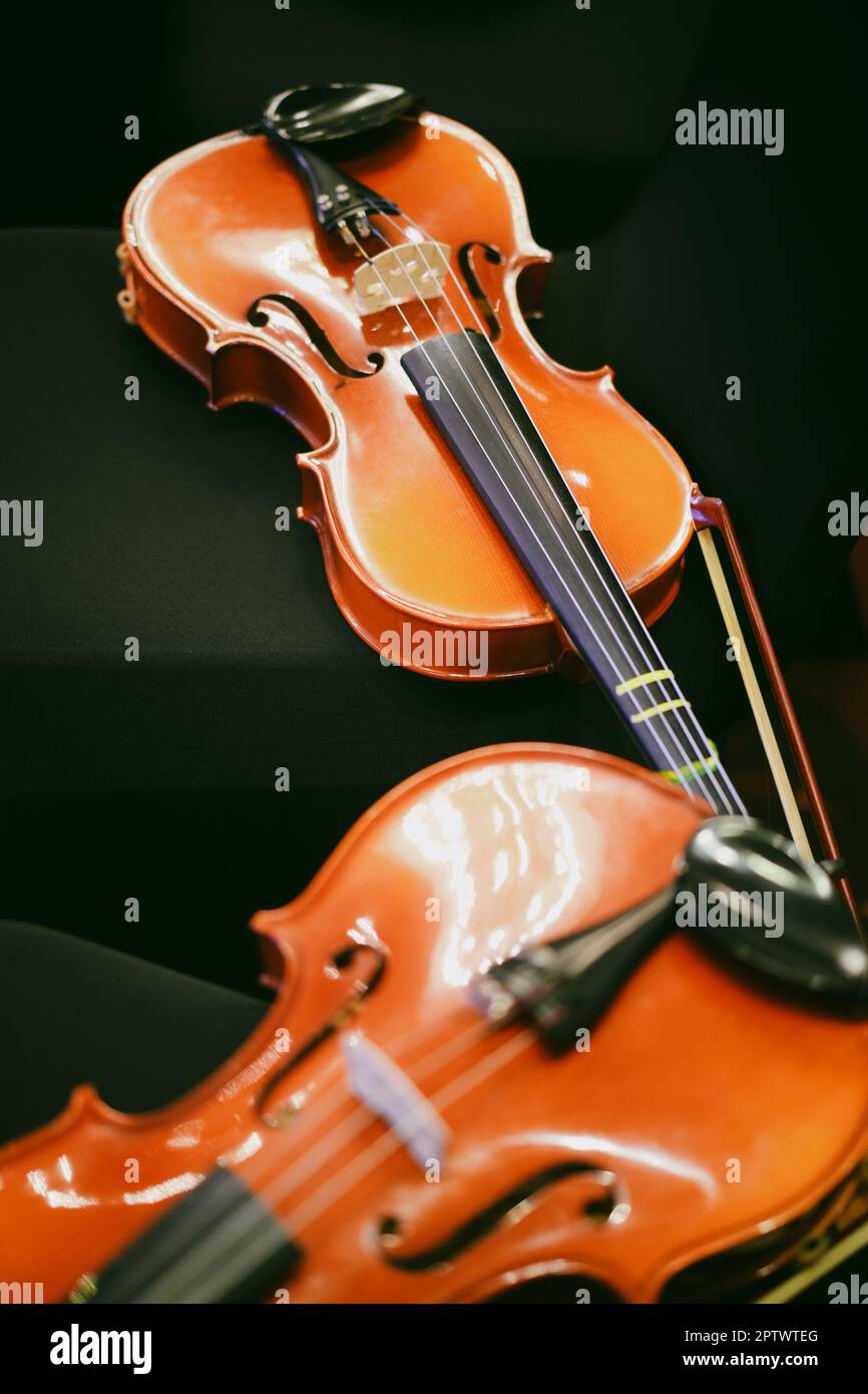Detail view of two violins on some chairs Stock Photo - Alamy