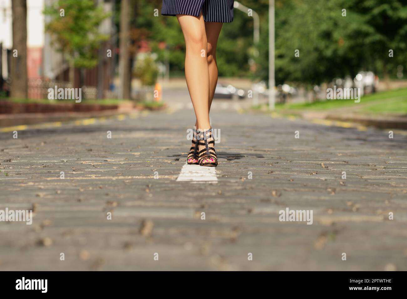 Female legs on old cobblestone pavement, view from the ground Stock ...