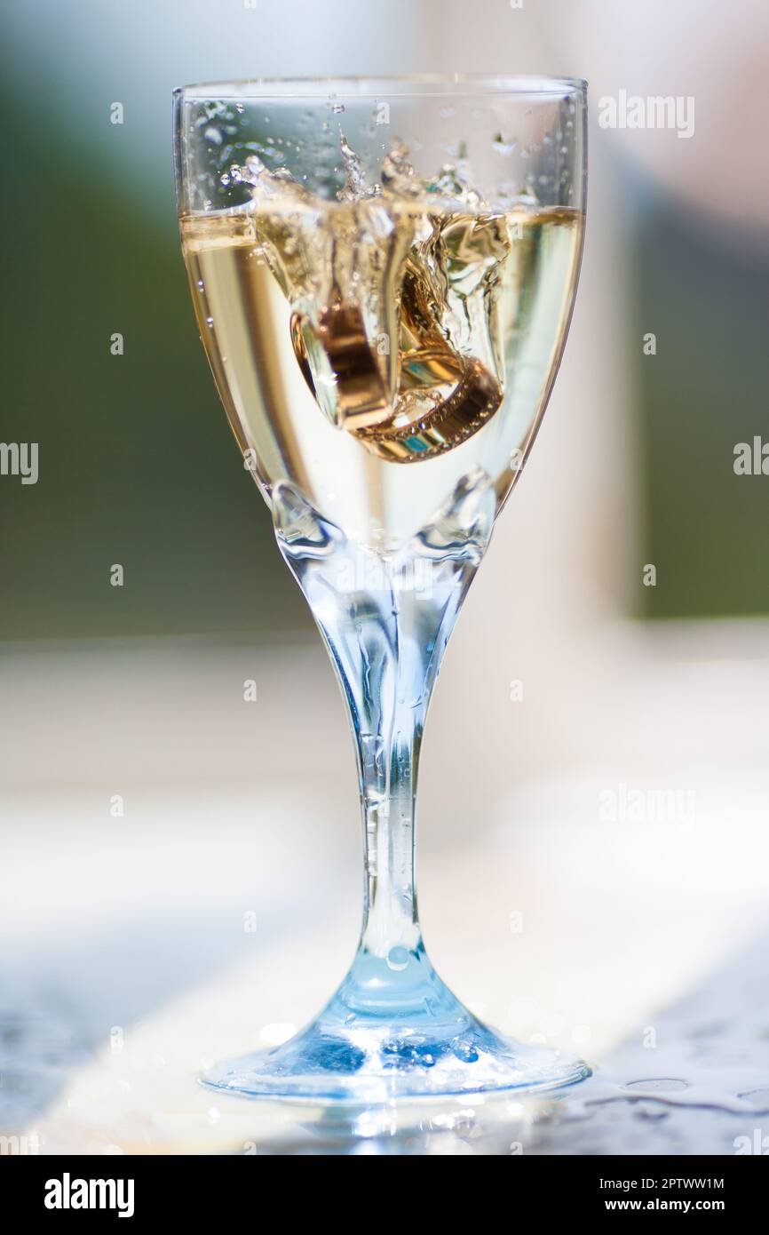Wedding rings falling glass hi-res stock photography and images - Alamy