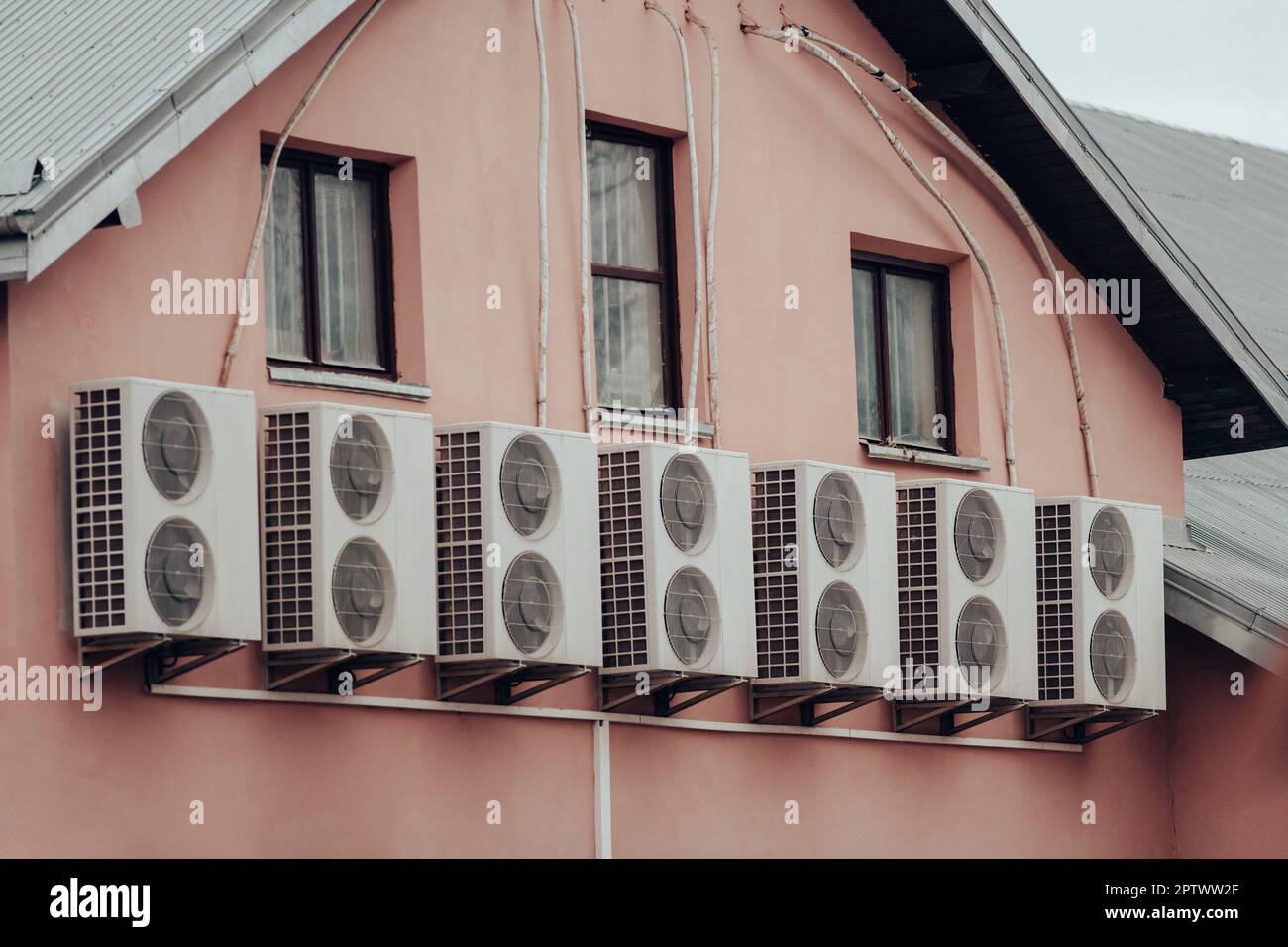 many air conditioners are fixed on the wall of the house Stock Photo ...