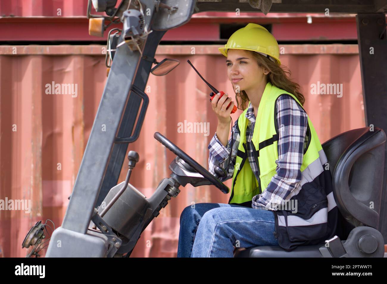 Young caucasian woman dressed in plaid pattern shirt, safety vest and ...
