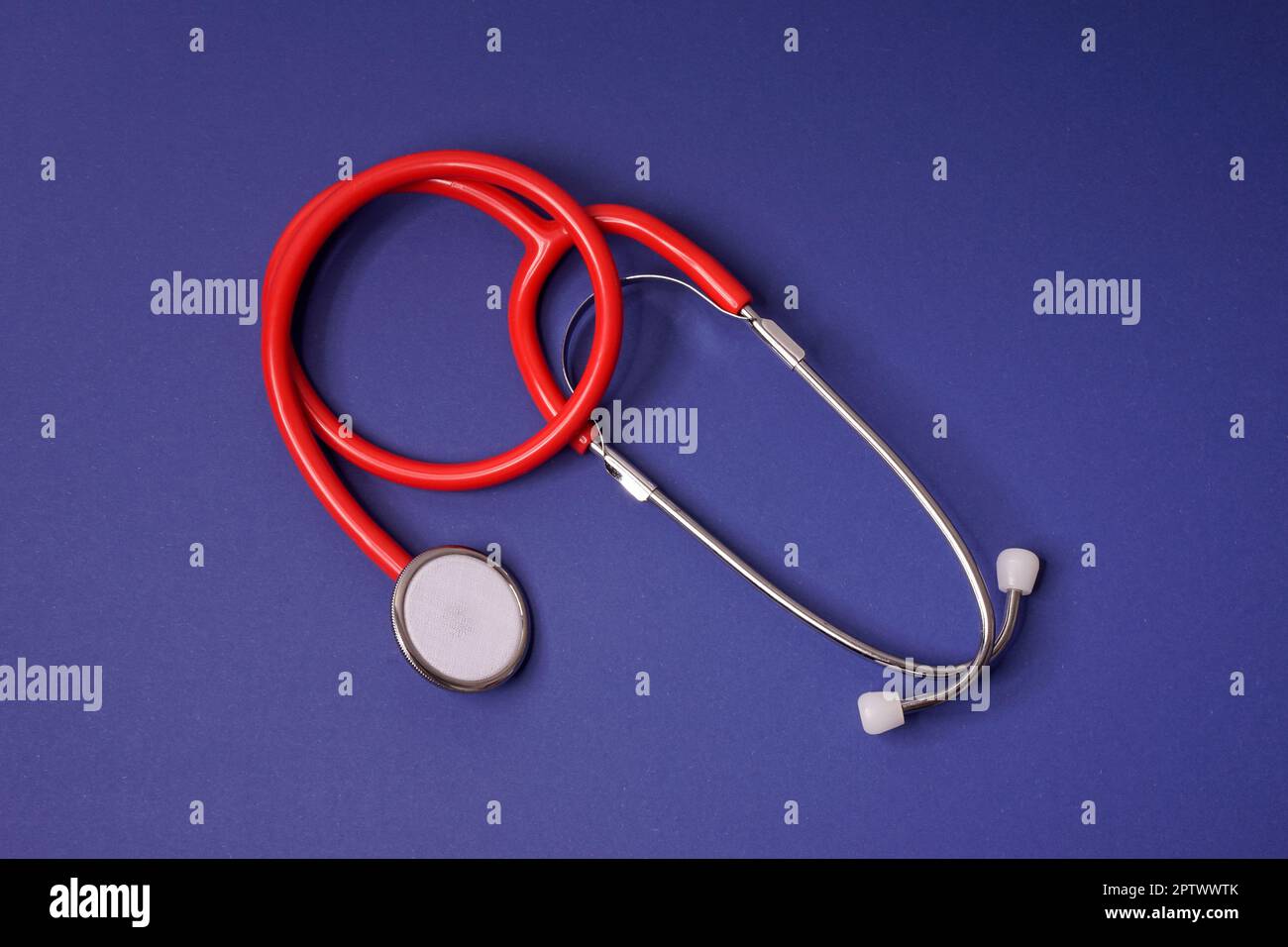 Red stethoscope, close up and still life of a modern stethoscope for ...