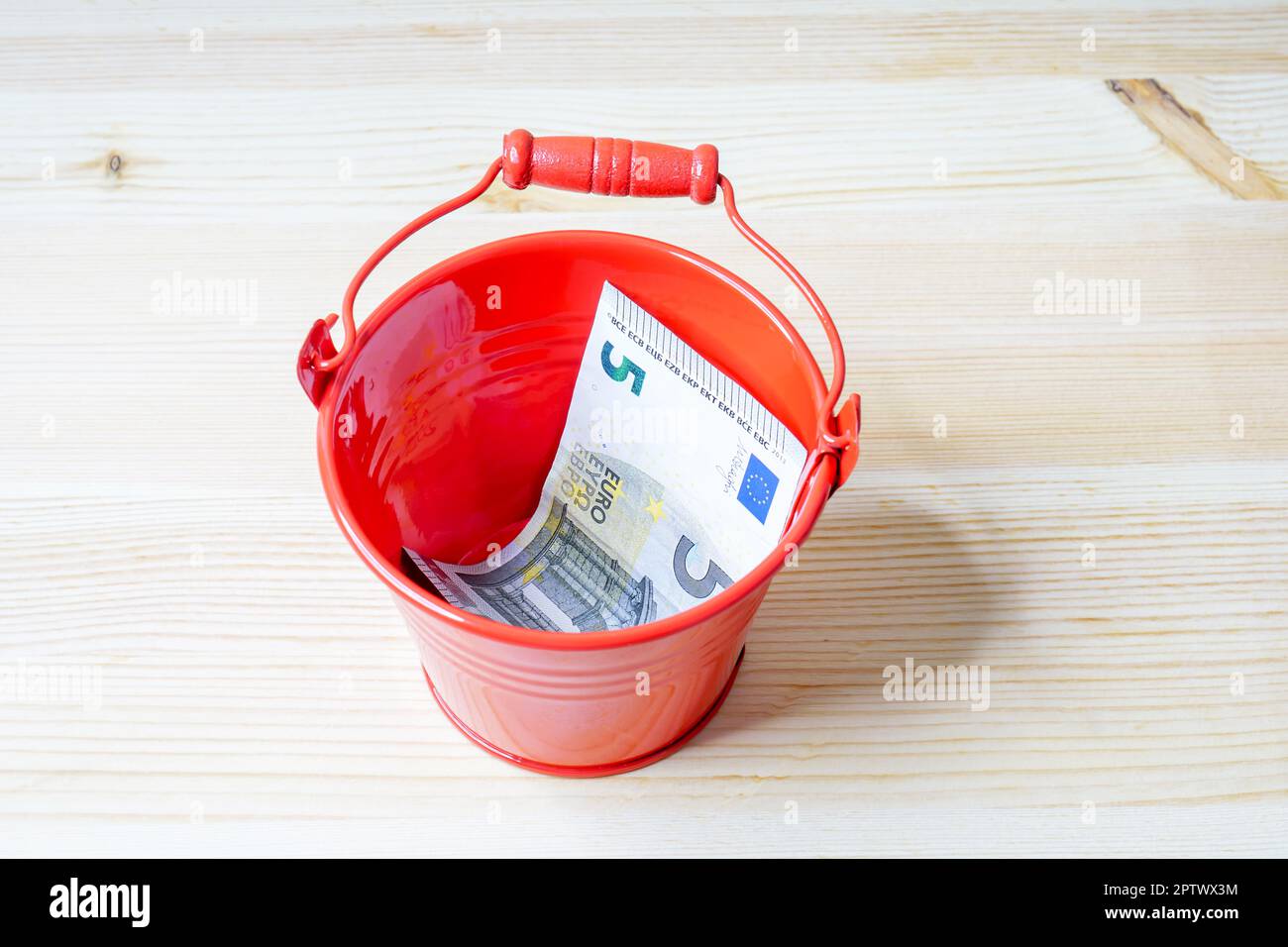Moneybox, Euro bill in bucket Stock Photo - Alamy