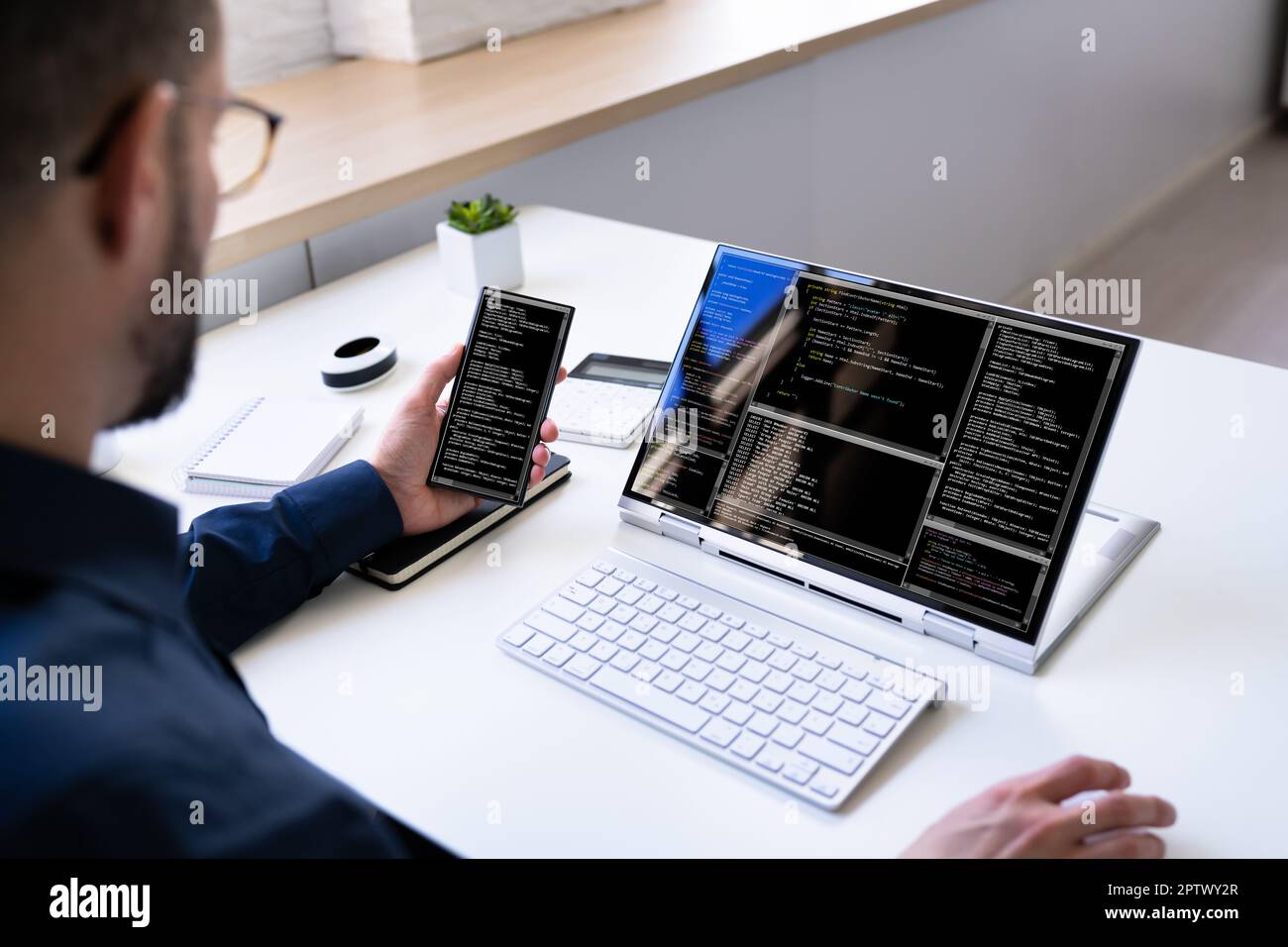 Programmer Or Coder At Office Desk Using Laptop Stock Photo - Alamy