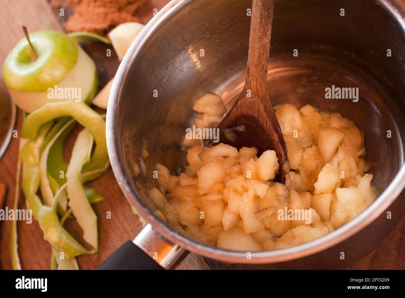 A peeled green apple and ingredients for an authentic homemade recipe ...
