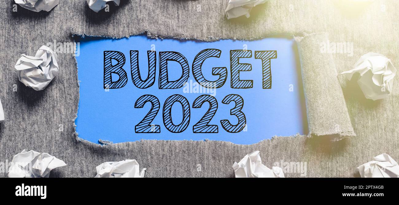 Hand writing sign Budget 2023, Business overview estimate of income and ...