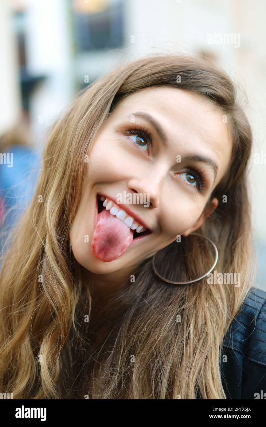 Close up photo of tricky girl making faces, sticking out tongue Stock ...