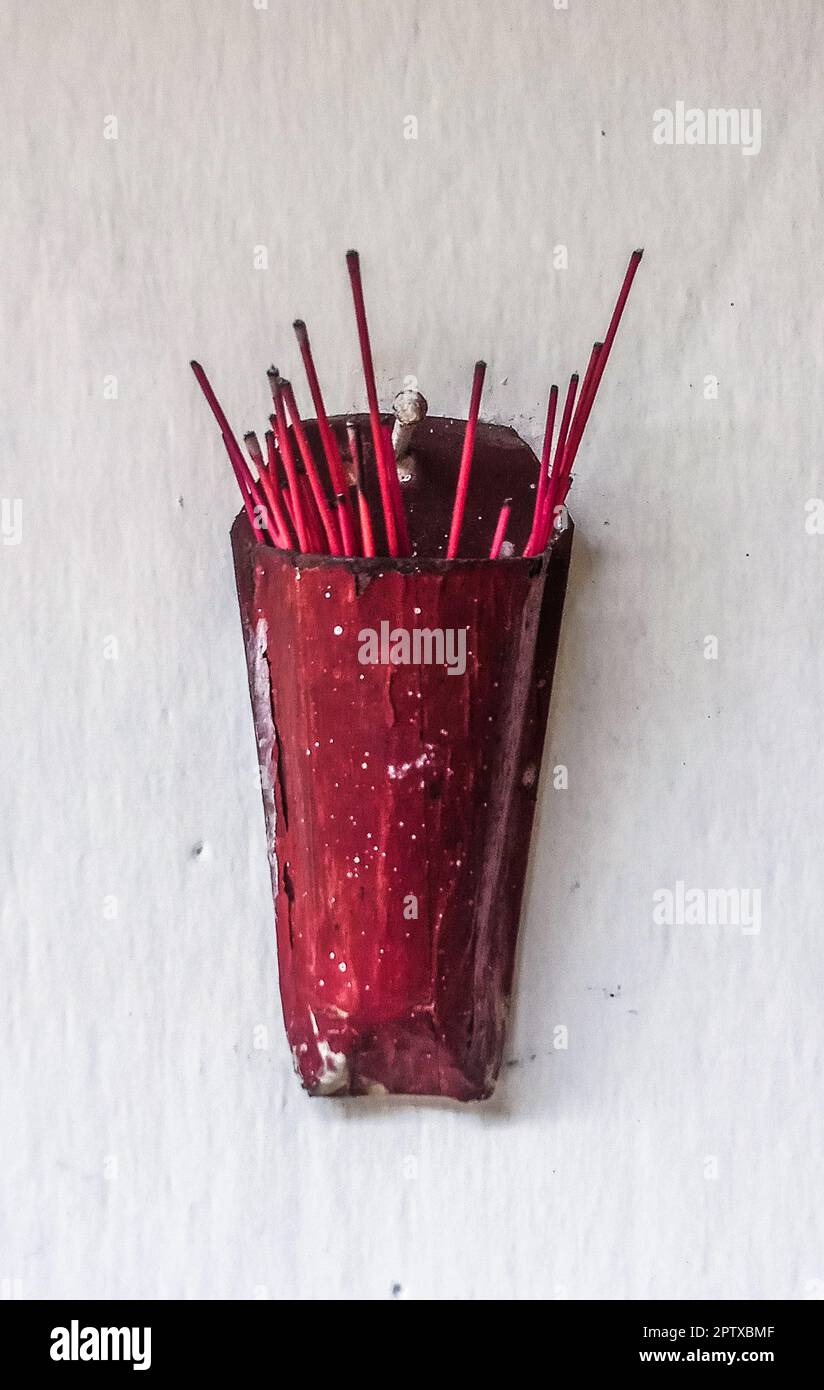A photo of a place to store red prayer incense sticks on the wall Stock ...