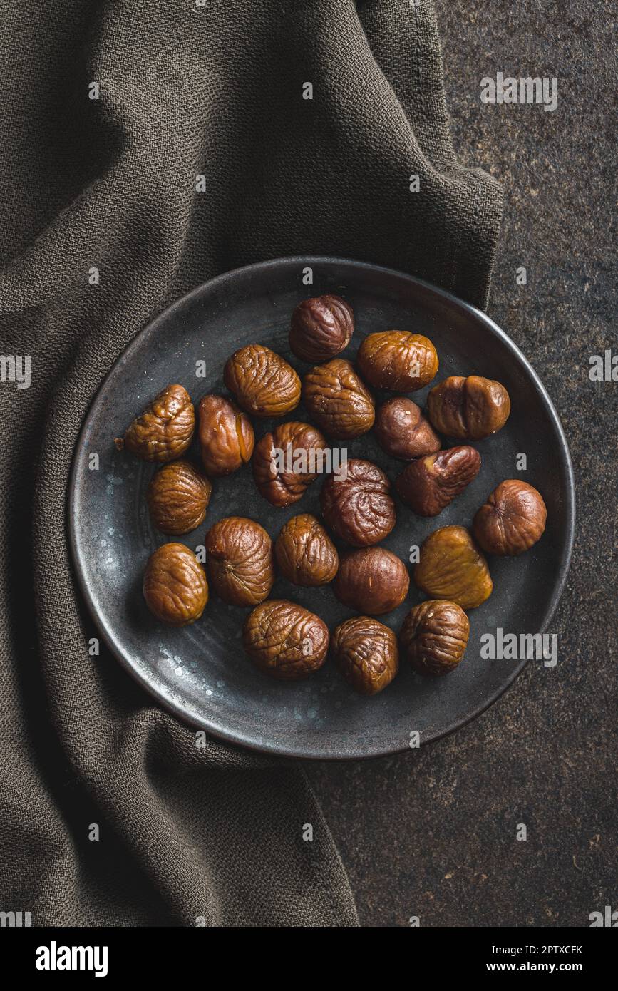 Peeled chestnuts. Sweet roasted chestnuts on the plate. Top view Stock ...