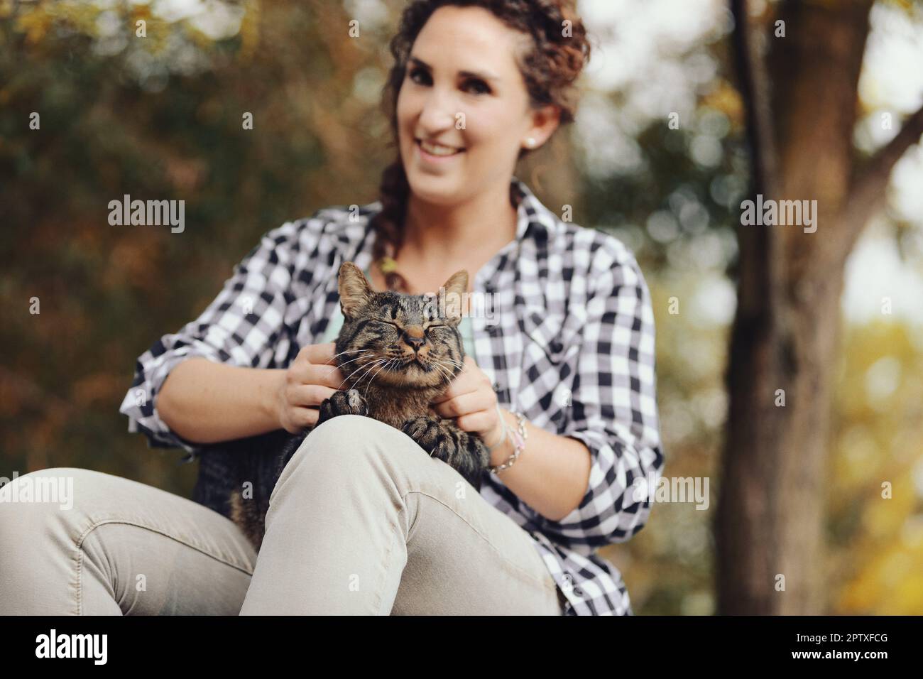 Normal girl strokes normal cat in normal forest. Isn't everything ...