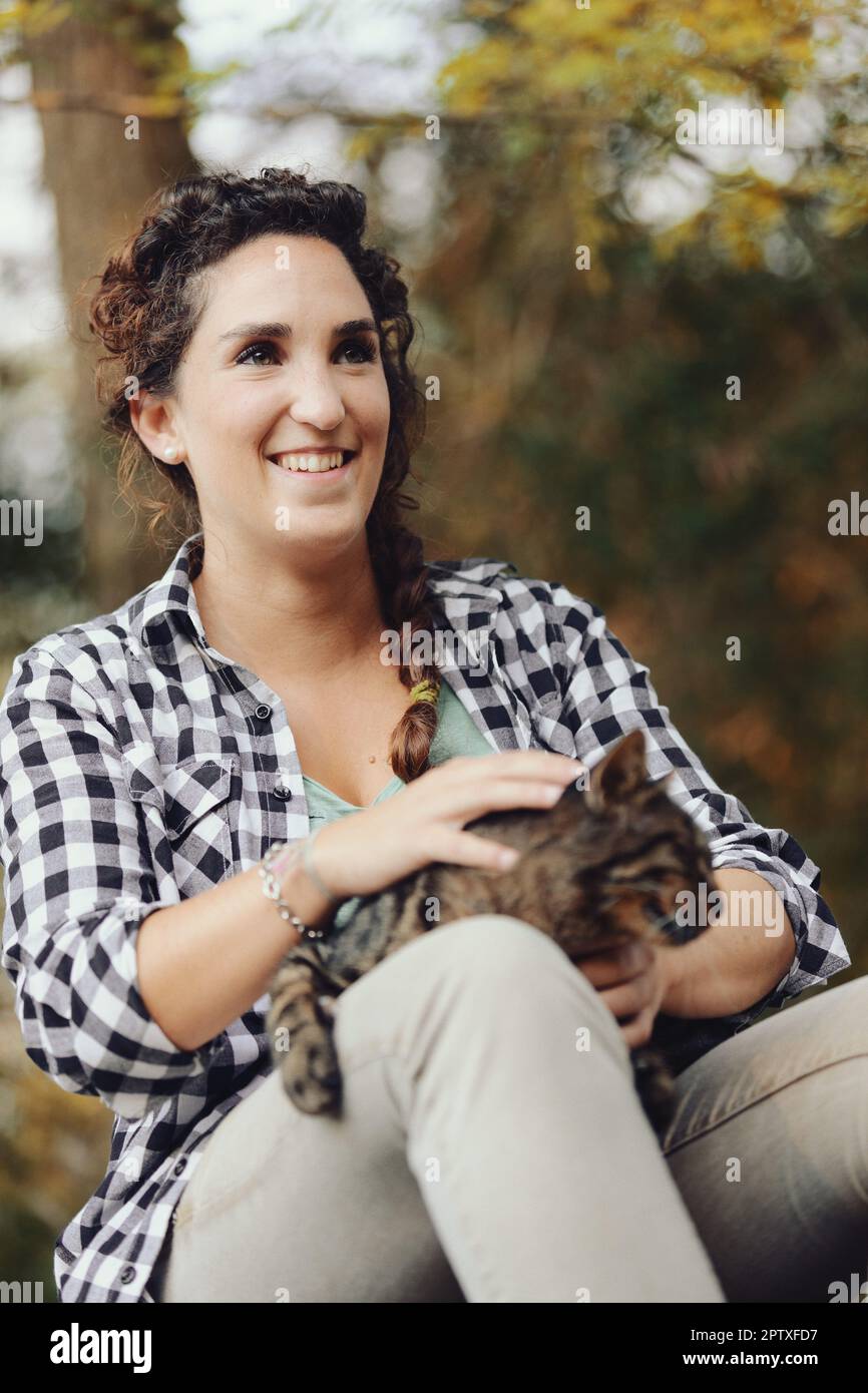 Normal girl strokes normal cat in normal forest. Isn't everything ...