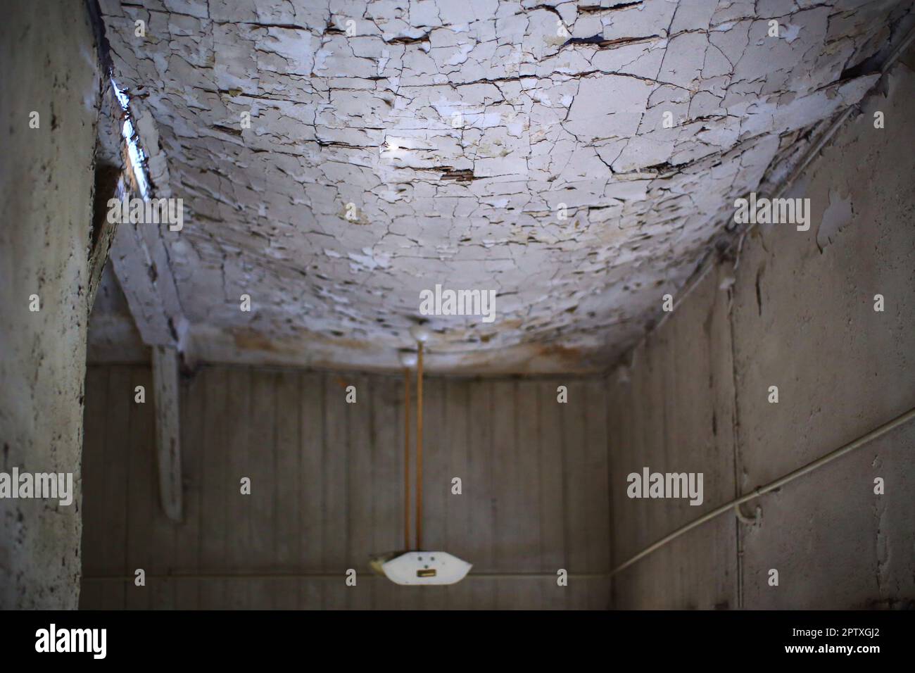 Crackig sagging ceiling in an abandoned building nearly collapsing ...