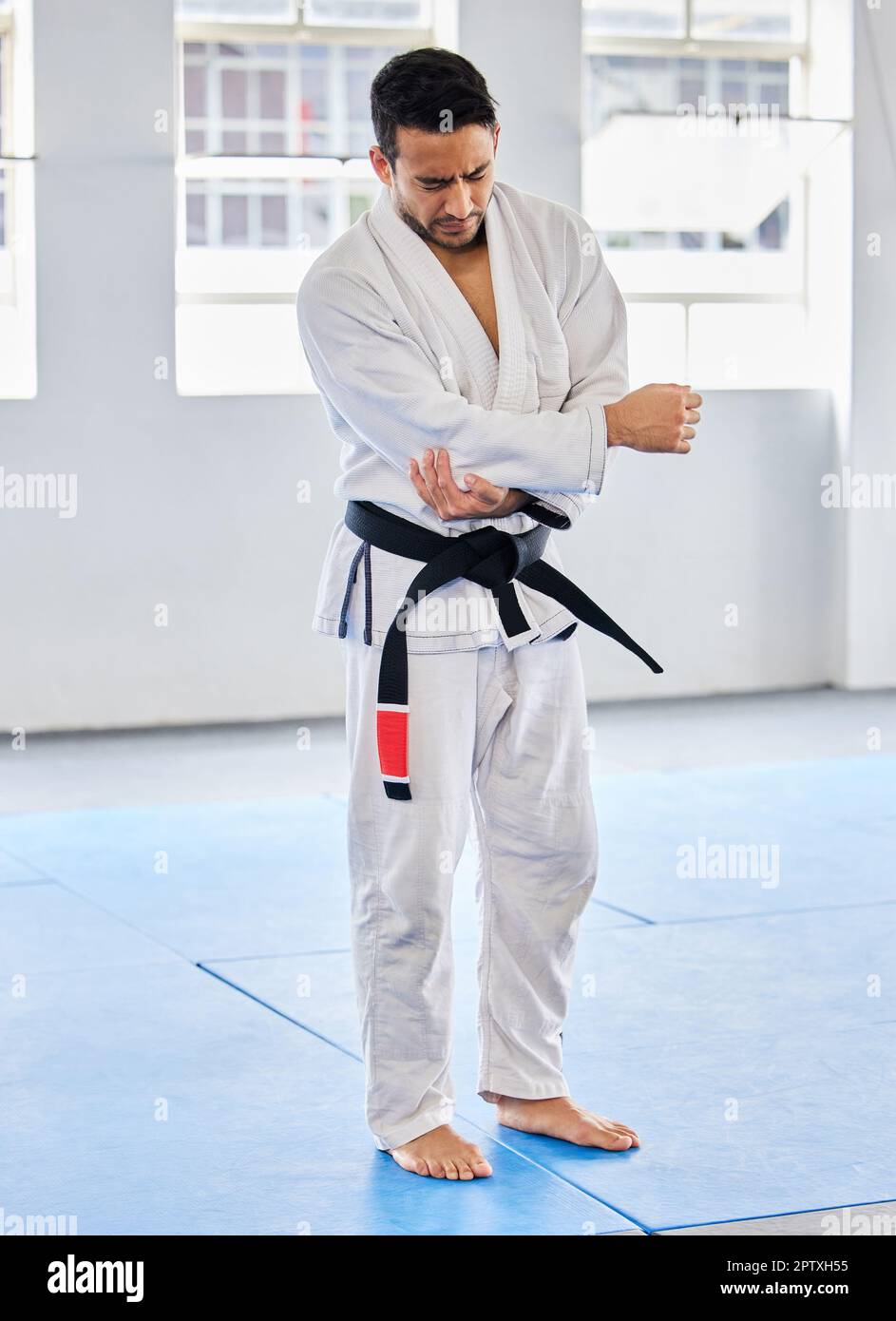 Karate injury, hurt and elbow pain for a man athlete holding painful ...