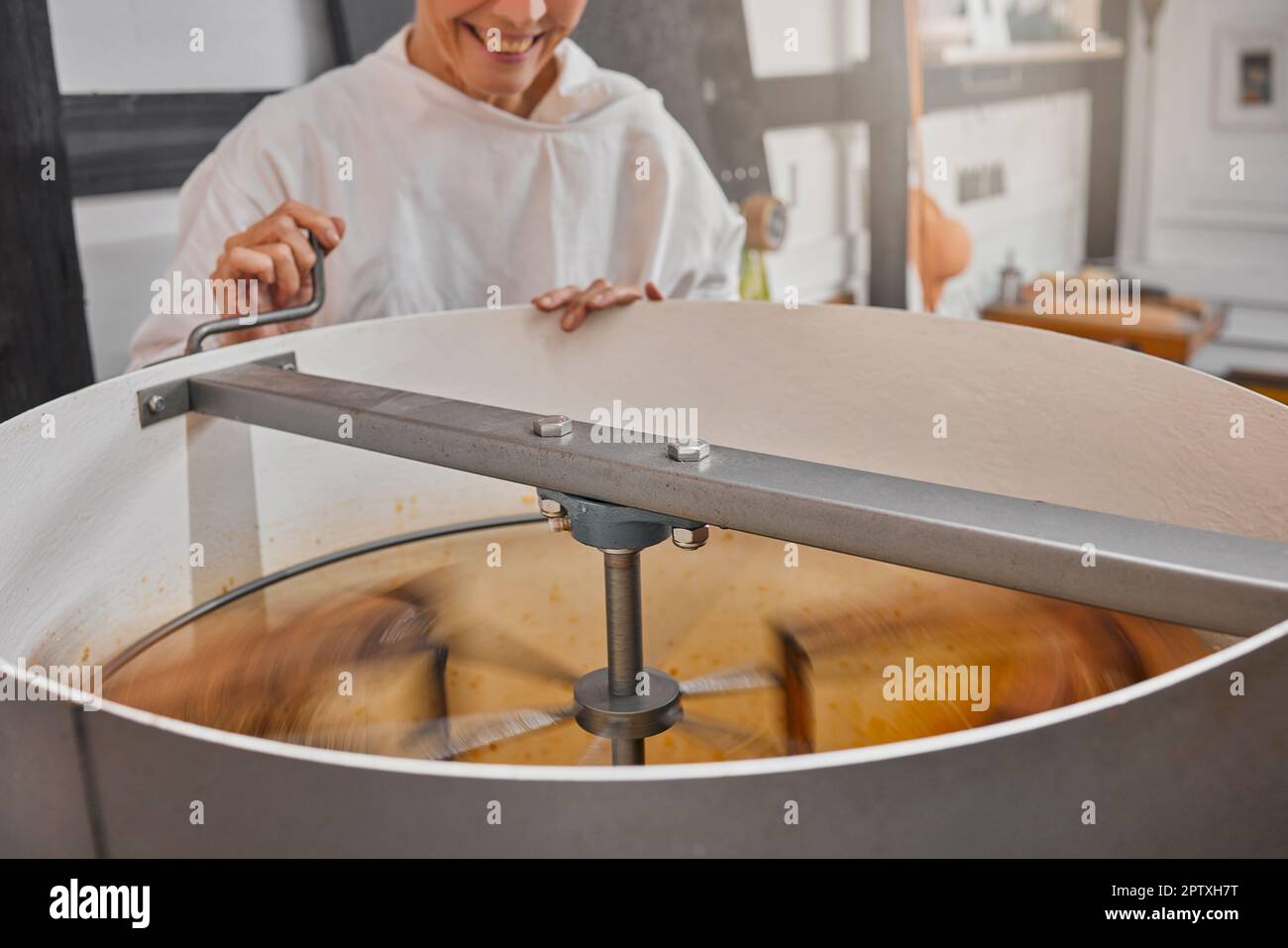 Machine, beekeeper and honey in production in a factory at sustainable ...