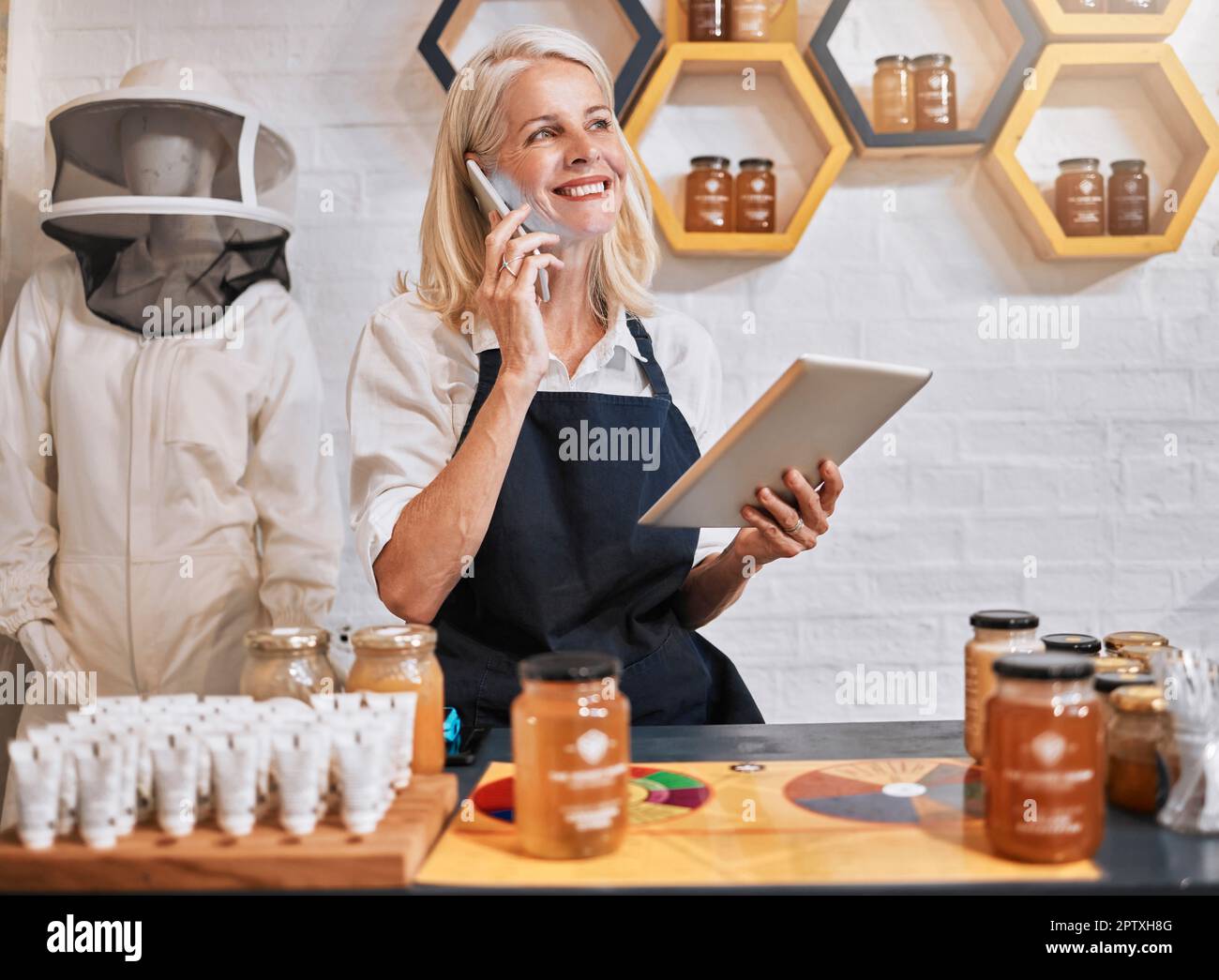 Phone call, honey and tablet with woman in store for natural product ...