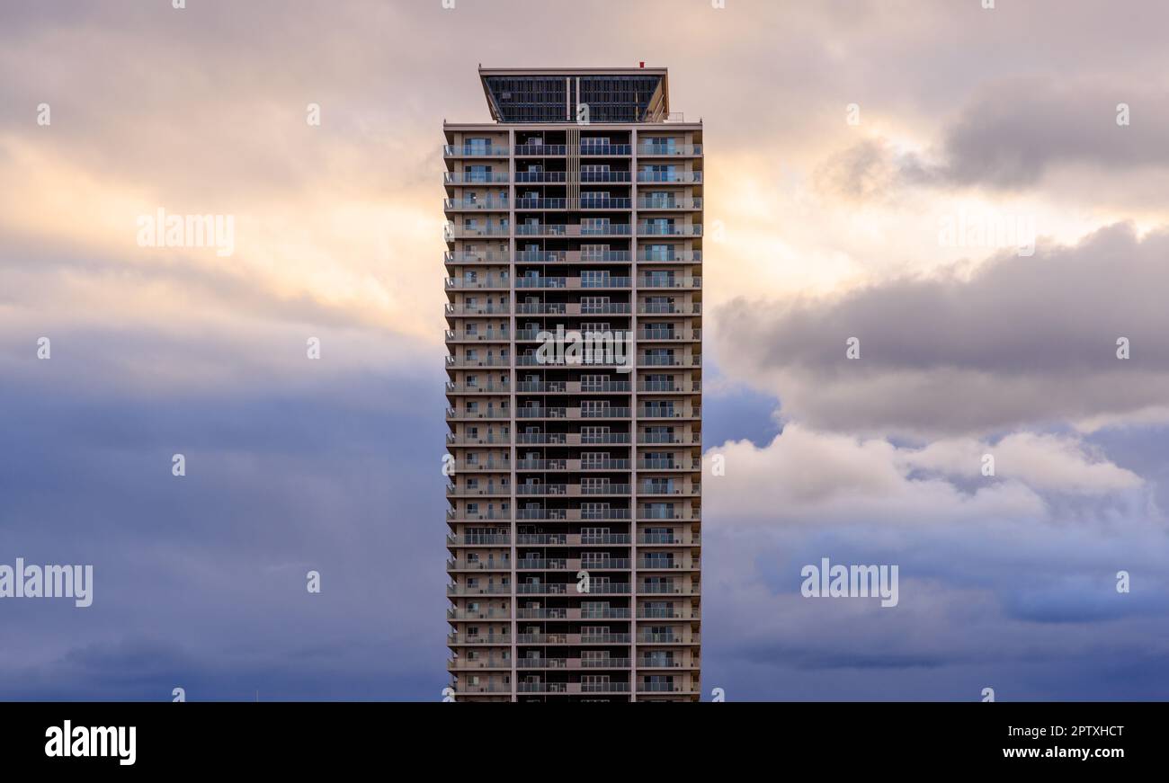 Dramatic sunset sky and tall residential tower with roof helipad Stock ...