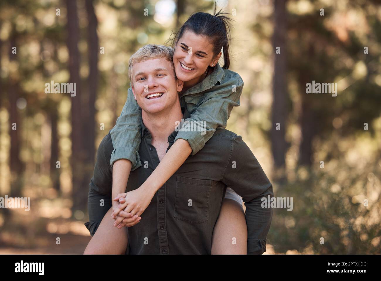 Couple, hug and smile for piggyback in nature walk, love and support ...