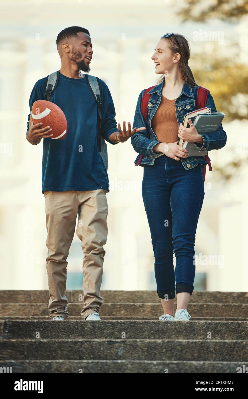 Students, couple and conversation in walk on stairs at college, university or school books ...