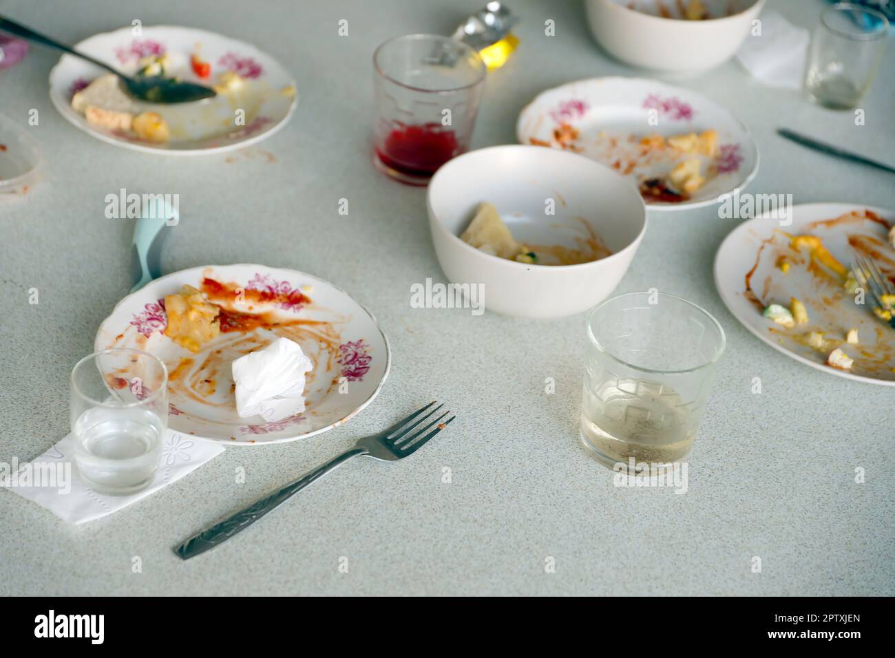 Empty dirty plates with spoons and forks on the table after meal ...