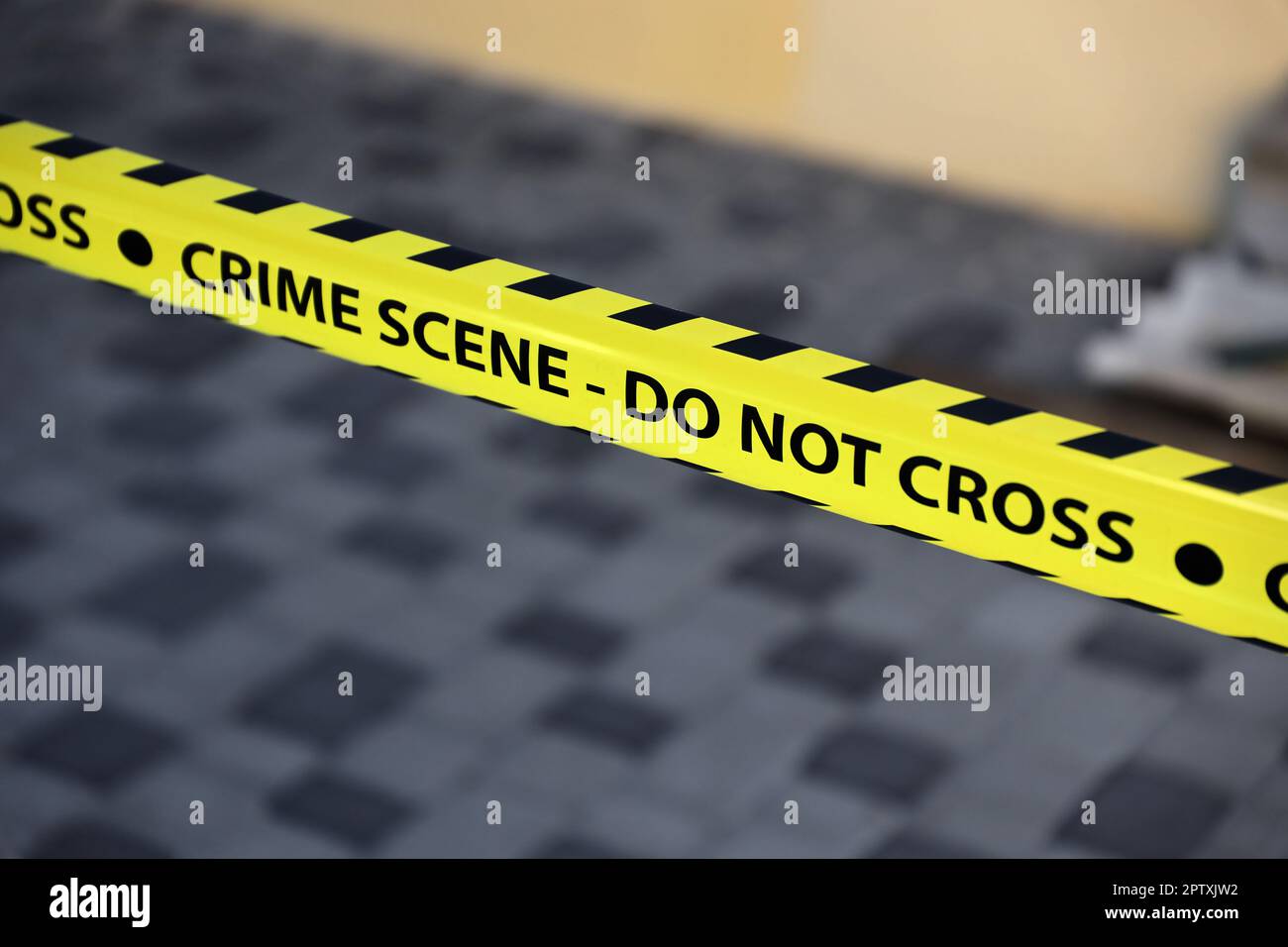 Crime scene tape for covering the area cordon. Yellow tape with blurred ...